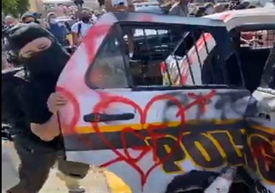 Police seek 2 suspects accused of vandalizing police vehicle during May ...