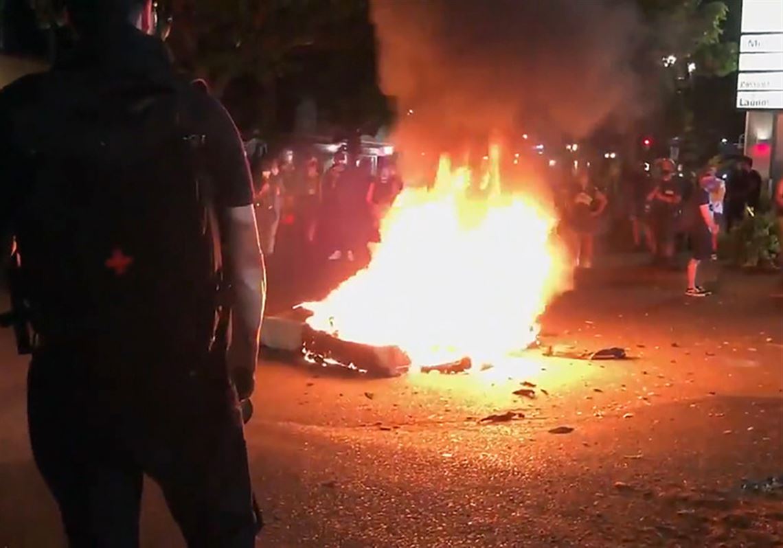 Protesters light small fire near Portland police precinct; 15 arrested ...