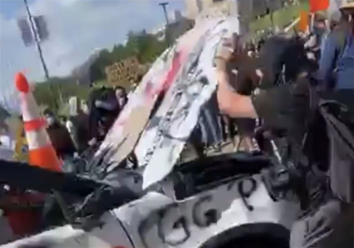 Police seek to identify two people accused of damaging police vehicle ...